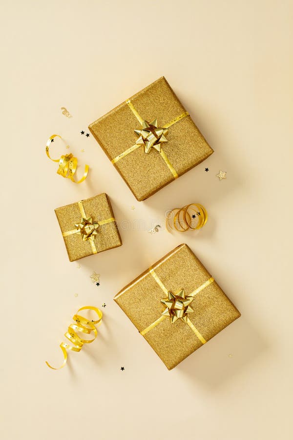Vertical Flat Lay of Three Wrapped Gifts with Ribbons and Confetti ...