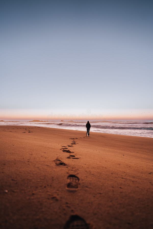 Vertical of Footsteps of a Man Walking on the Sand Along the Beach at ...