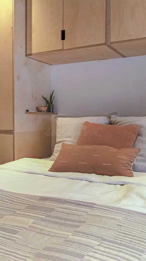 Vertical Frame Bedroom Interior of Home with Built in Cabinets Over and ...