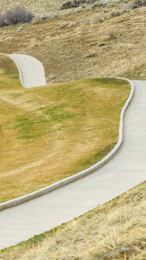 Vertical Frame Close Up of a Paved Pathway Running through the Slope of ...