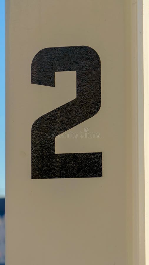 Vertical Frame Close Up of White Rectangular Posts with Numbers Painted ...