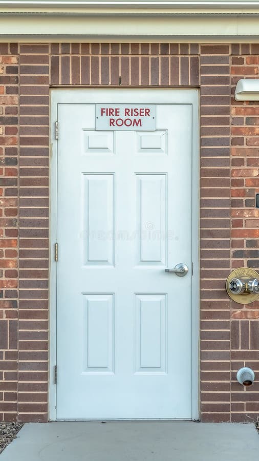 Vertical Frame Fire Riser Room Sign on the White Wood Door of a ...