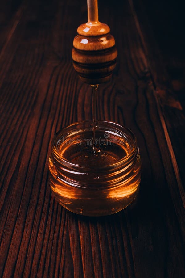Vertical Frame Honey Dripping into Jar on a Table Stock Photo - Image ...