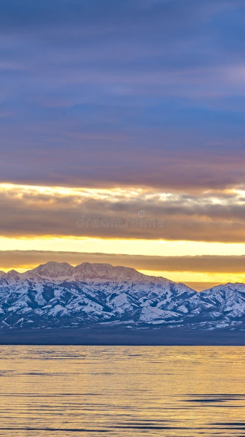 Vertical Frame Panoramic View of a Shiny Lake and Mountain Covered with ...