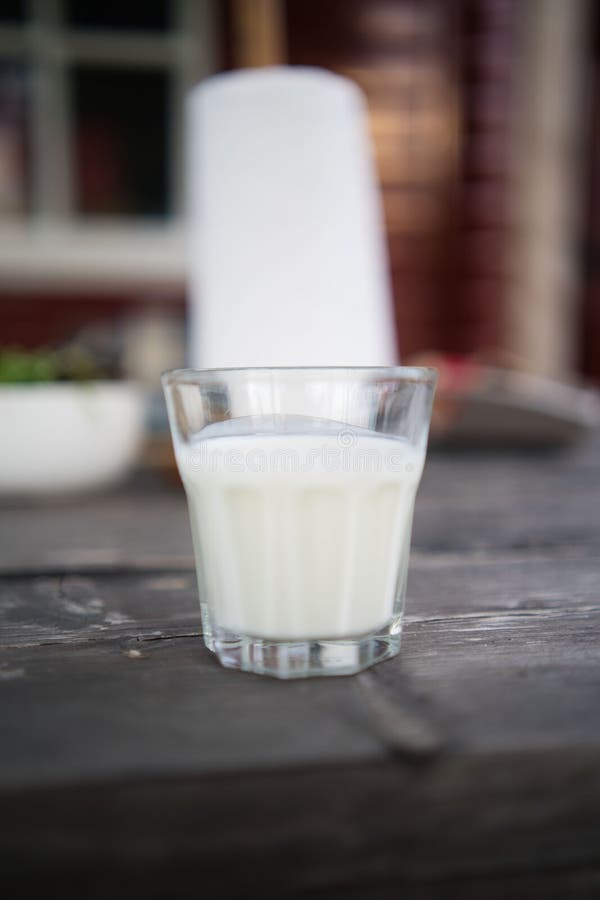 Vertical of a Glass of Milk on a Table Outside Stock Photo - Image of ...