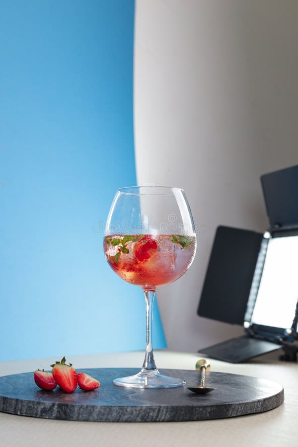 Vertical of a Glass of Red Gin Tonic with Strawberries in a Studio ...