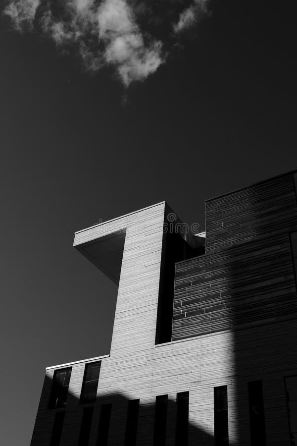 Vertical Gray Scale Shot of a Building Under a Cloudy Sky Editorial ...