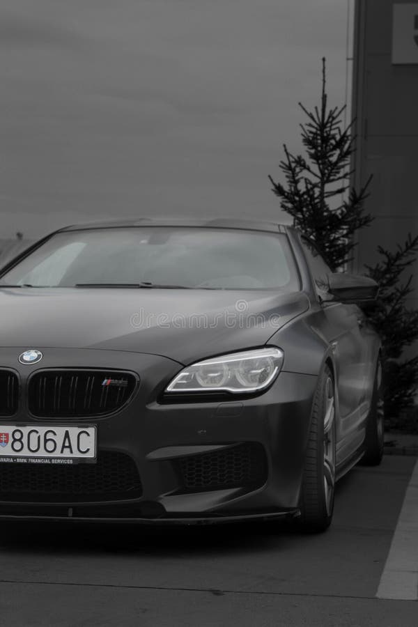 Vertical Grayscale of a BMW Parked Outdoors Editorial Photography ...