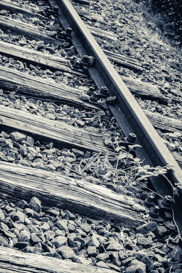 Vertical Grayscale Closeup Shot of Train Tracks Stock Photo - Image of ...