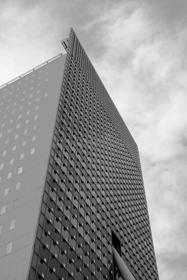 Vertical Grayscale Low Angle Shot of a High-rise Building Under the ...