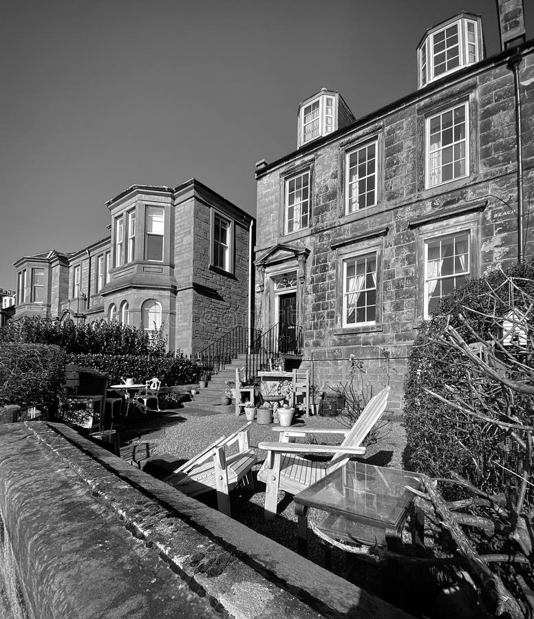 Vertical Grayscale of Old Buildings with Chairs in Front of Them Stock ...