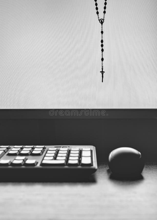 Vertical Grayscale Shot of a Cross Hanging Against the Screen with a ...