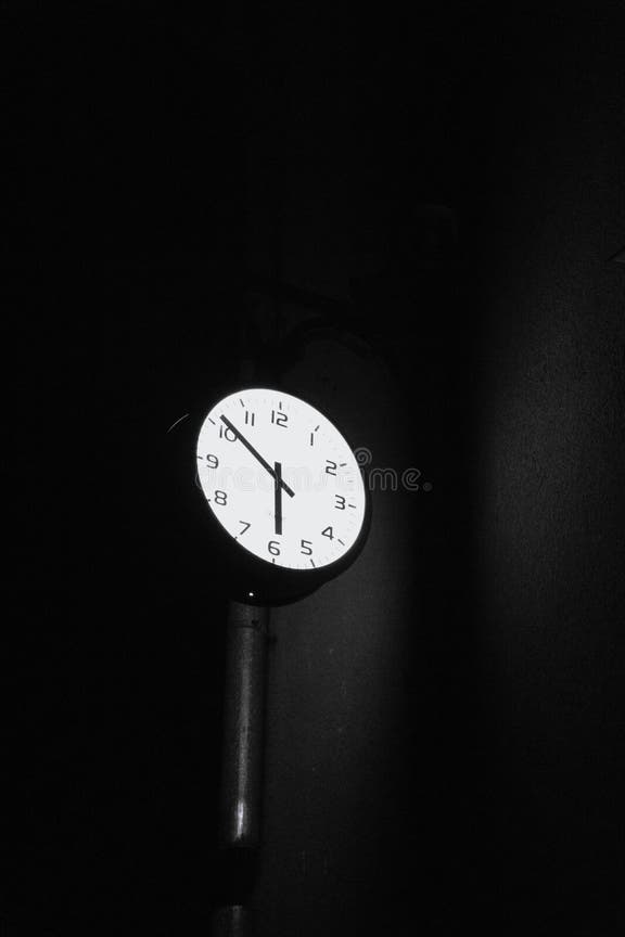 Vertical Grayscale Shot of a Round Decorative Small Clock Stock Photo ...