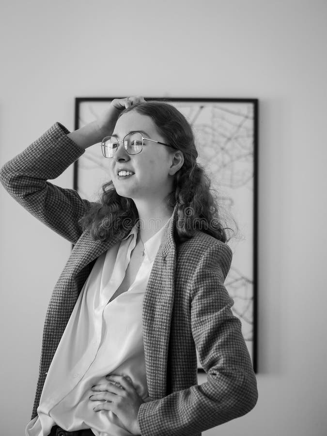 Vertical Grayscale of a Woman Posing on the Background of a Framed ...