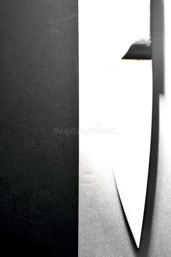 Vertical Grey Scale Shot of a Knife on a Black and White Surface ...
