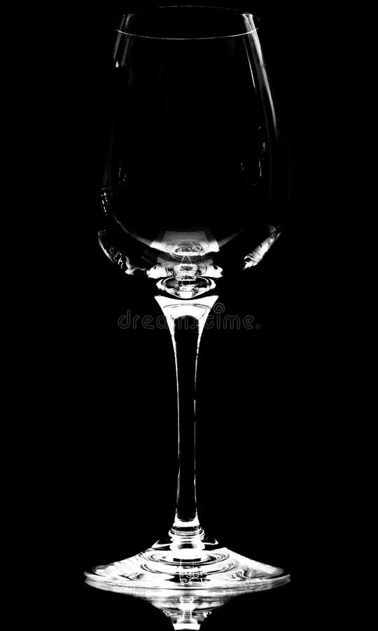 Vertical Greyscale of an Empty Glass Under the Lights Against a Black ...