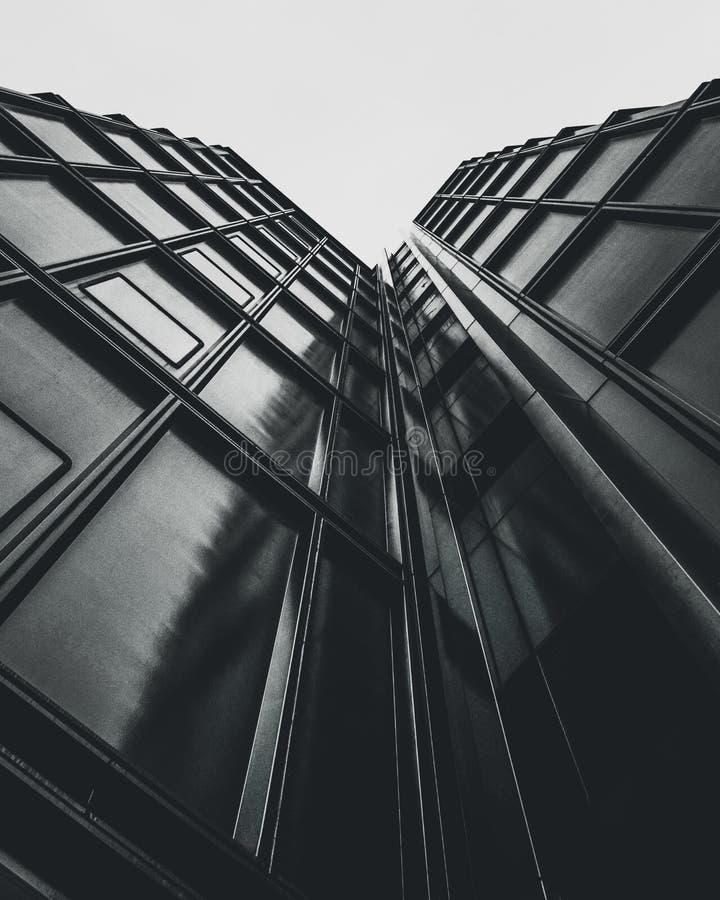 Vertical Greyscale Low Angle Shot of the Facade of a Modern Building ...