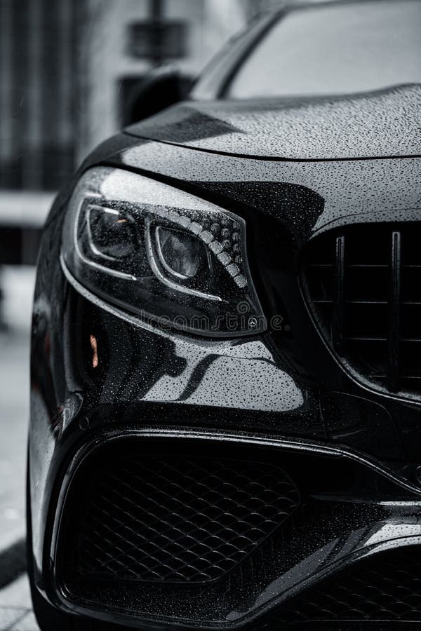 Vertical Greyscale Shot of a Black Car Front Stock Photo - Image of ...