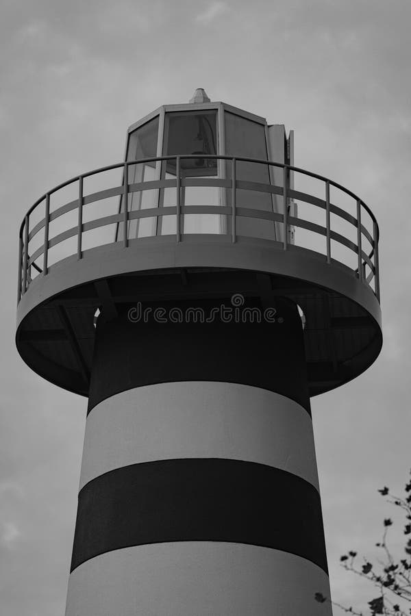A Vertical Greyscale Shot of a Lighthouse Top Stock Photo - Image of ...