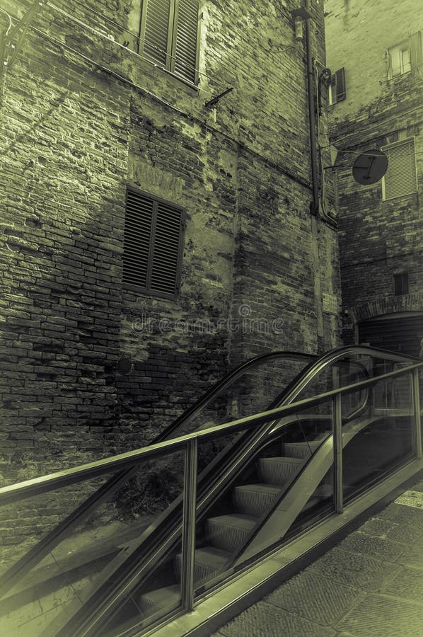 Vertical Greyscale Shot of an Old Building with Brick Walls and Next To ...