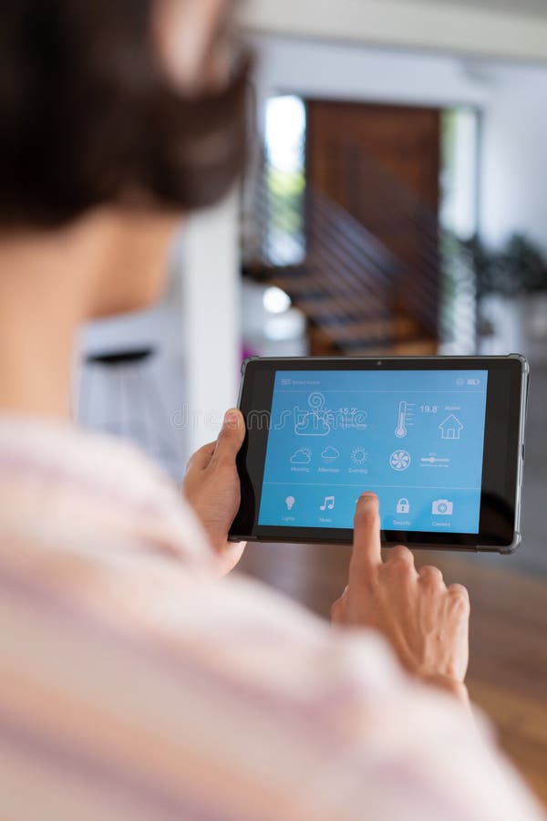 Vertical of Hands of Biracial Man at Home Using Tablet with Smart Home ...