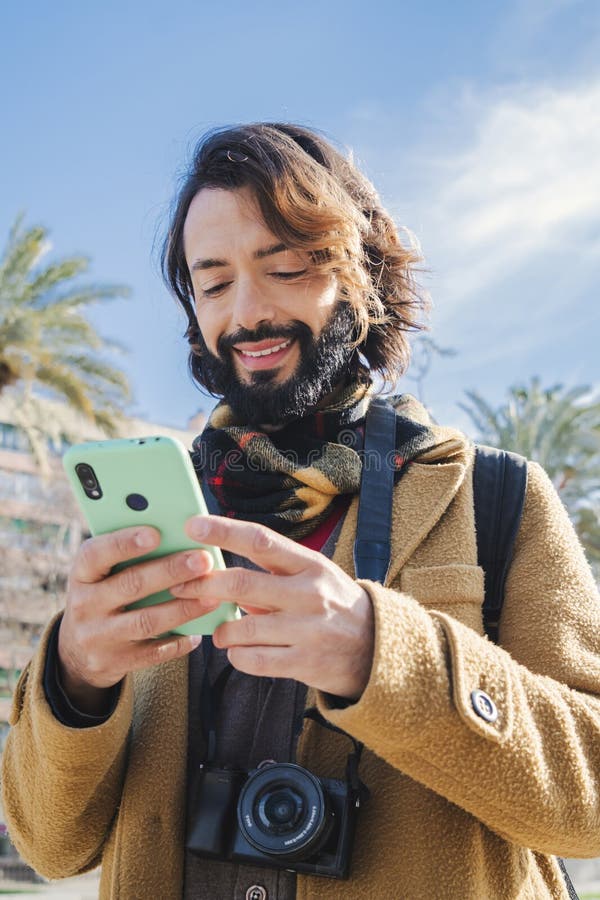 Vertical Happy Bearded Man Using a Cellphone App for Browsing on ...