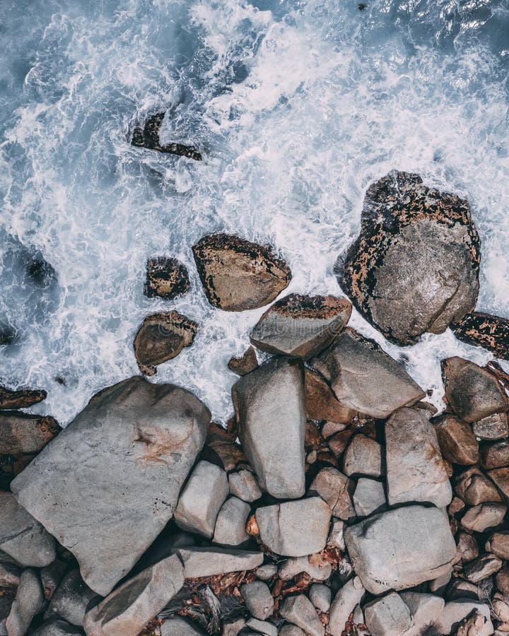 Vertical High Angle Shot of Big Stones in the Stormy Ocean Water Stock ...