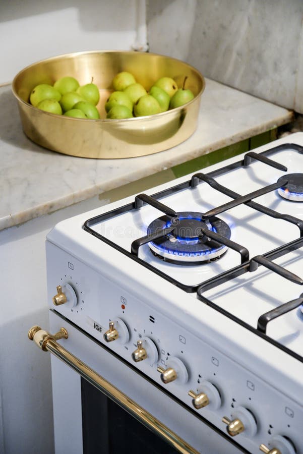 Vertical High Angle Shot of a Burning Stove and a Bowl with Pears in ...