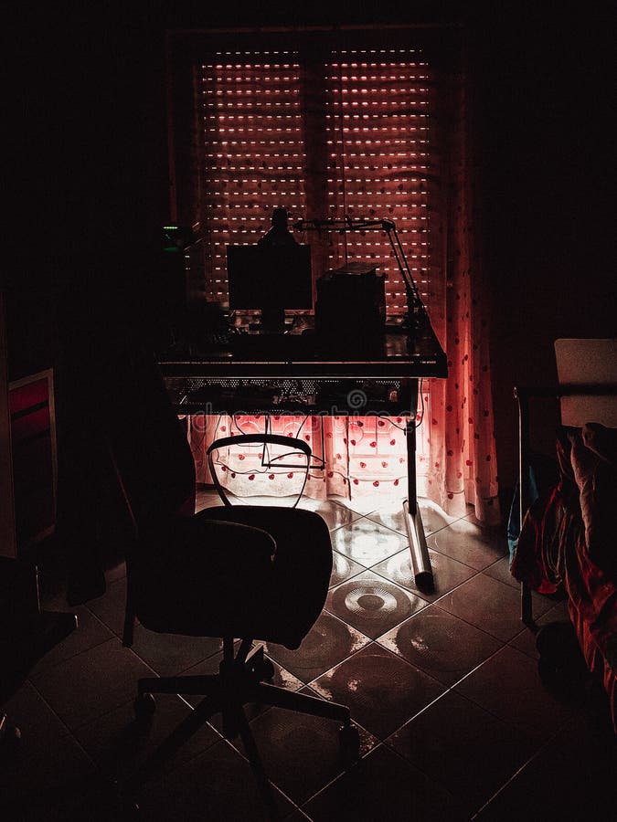 Vertical High Angle Shot of a Dark Workplace Near a Panoramic Window ...
