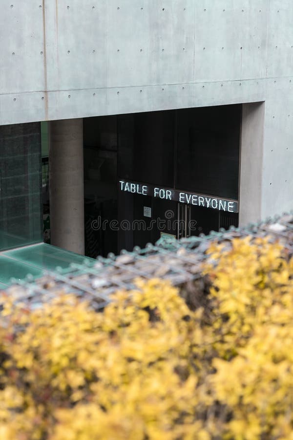 Vertical High Angle Shot of the Entrance of a Cafe in a Cement Building ...