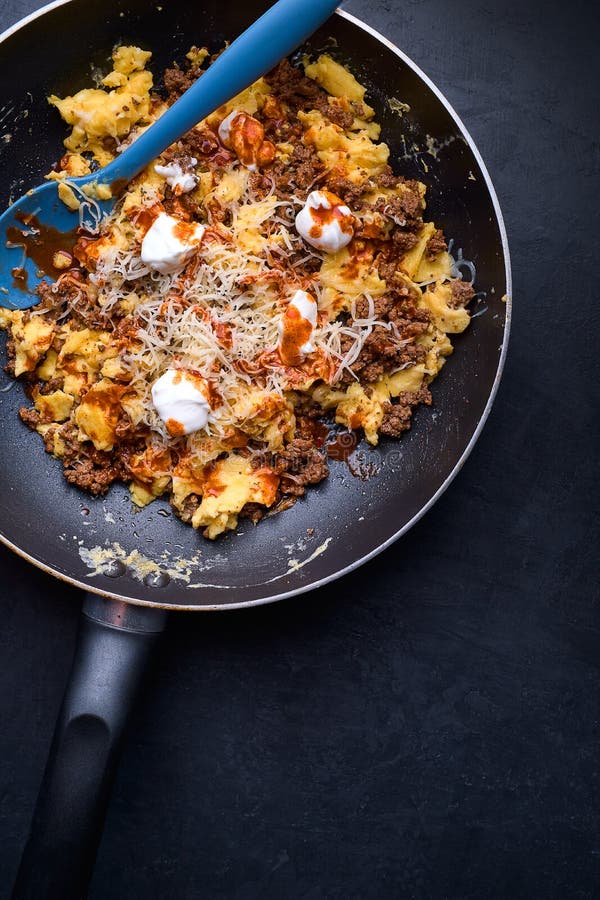 Vertical High Angle Shot of Meat with Melting Cheese Being Cooked in a ...