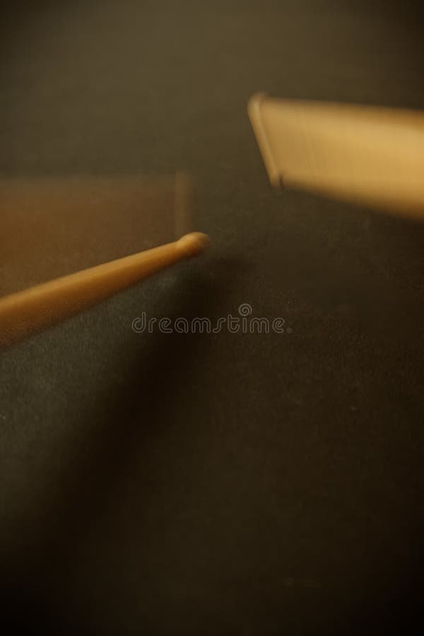 Vertical High Angle Shot Of A Pair Of Drum Sticks Drumming On A Black ...