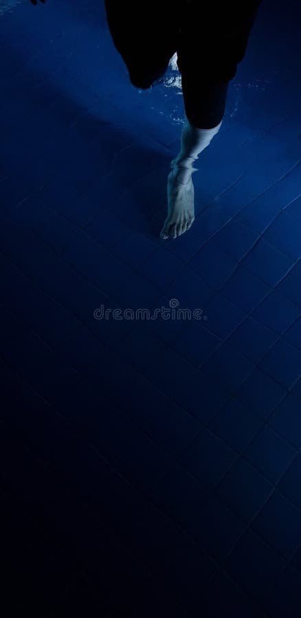 Vertical High Angle Shot of a Person Walking in a Pool Stock Photo ...