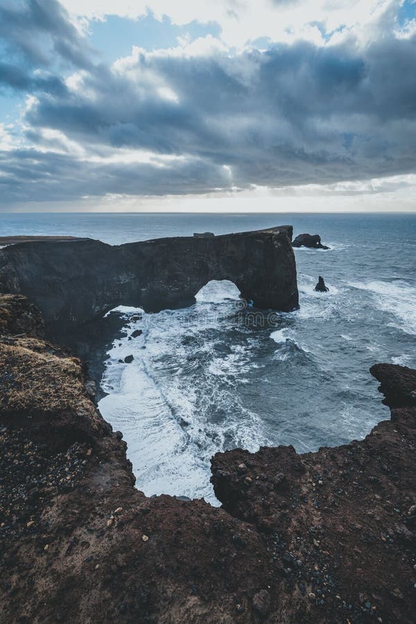 Vertical High-angle Shot of the Sea Waves Crashing on the Cliffs of the ...