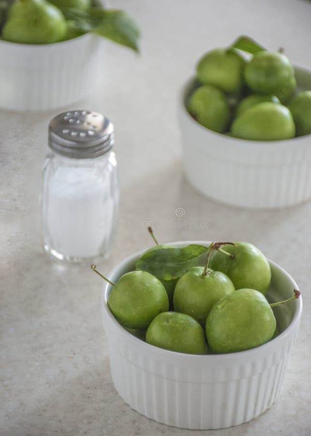Vertical High Angle Shot of Small Green Apples in White Bowls and Salt ...