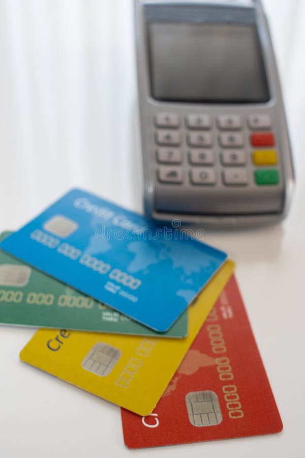 Vertical High Angle Shot of Some Credit Cards and a Card Machine on a ...