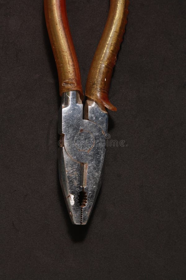 Vertical High Angle Top View Closeup Shot Of Pliers On A Black Table ...