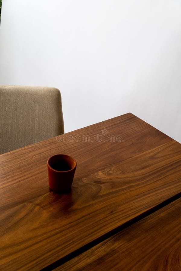 Vertical High Angle View of a Stylish Red Cup on a Wooden Dining Table ...