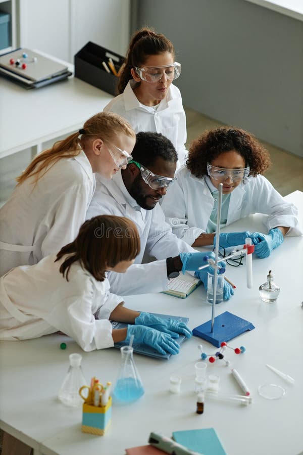Teacher and Students Doing Experiment in Class Stock Photo - Image of ...