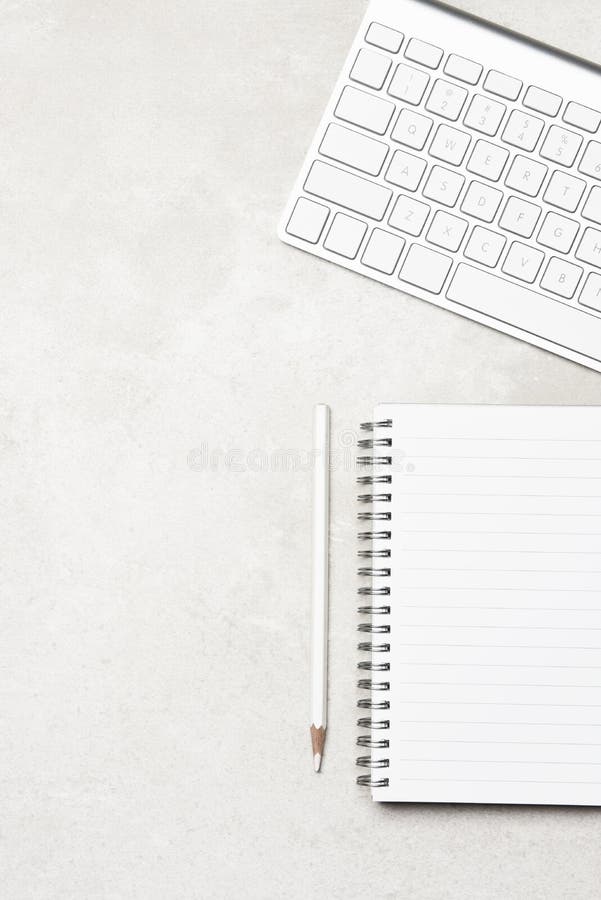 Vertical High Key Workspace: a Note Pad with White Pencil and Computer ...