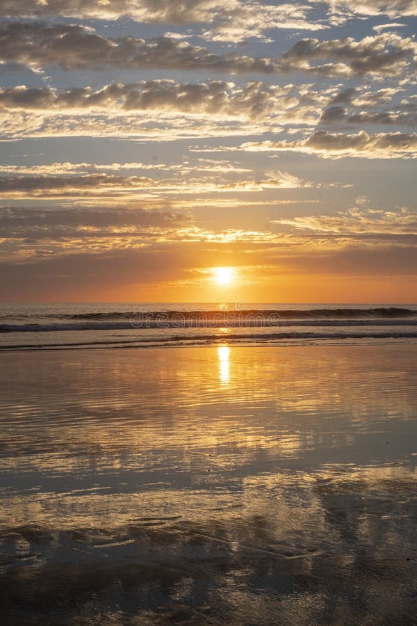 Vertical Image of a Beautiful Orange Sunset Over the Ocean Stock Photo ...