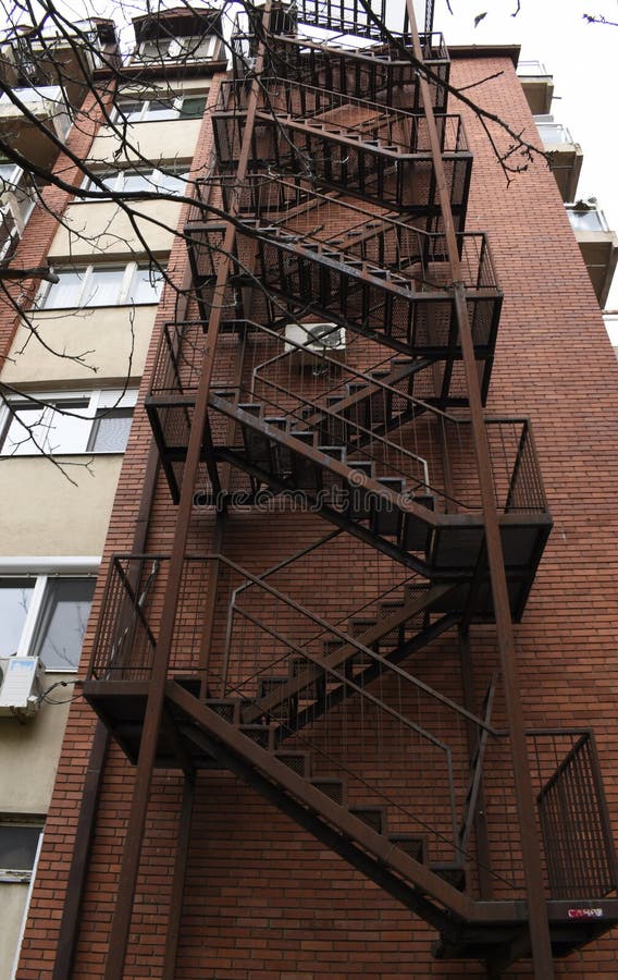 A Brown Building with Fire Escape Editorial Stock Photo - Image of vertical, bricks: 353203328