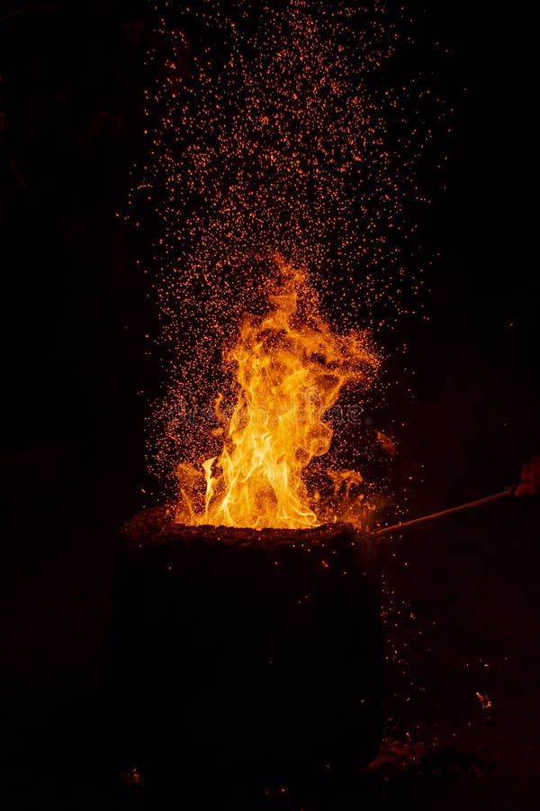 Vertical Image of a Burning Log with Flying Sparks Creating a Fiery ...