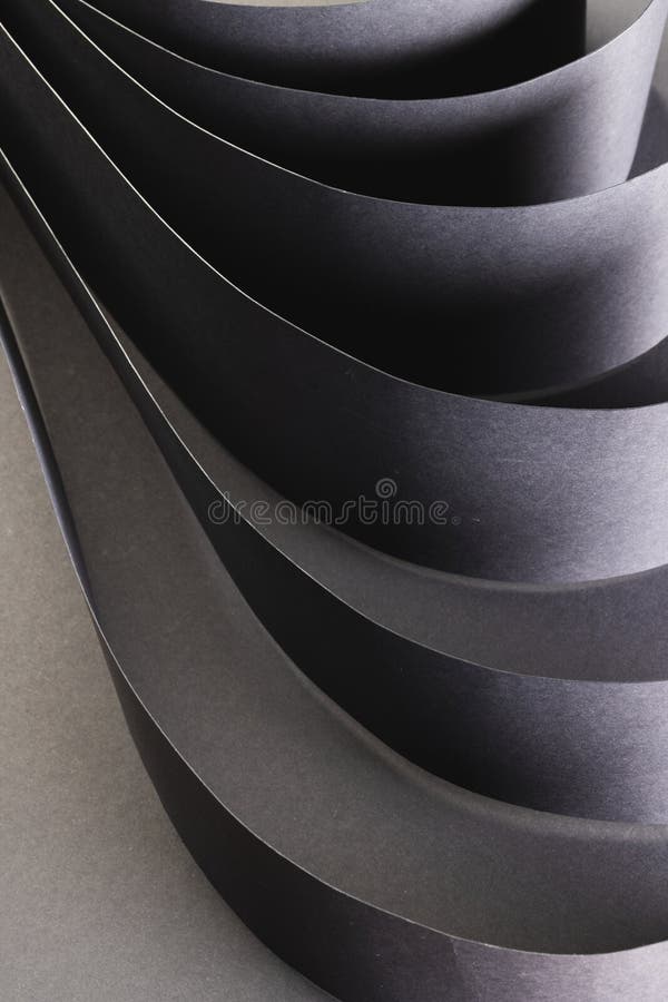 Vertical Image of Close Up of Rolled Up Pieces of Black Paper with Copy ...
