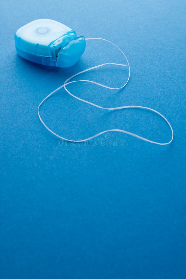 Vertical Image of Dental String on Blue Surface Stock Photo - Image of ...