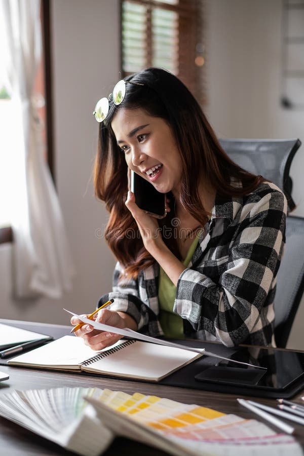 Graphic Designer Talk about Work with Mobile Phone at Office Stock ...