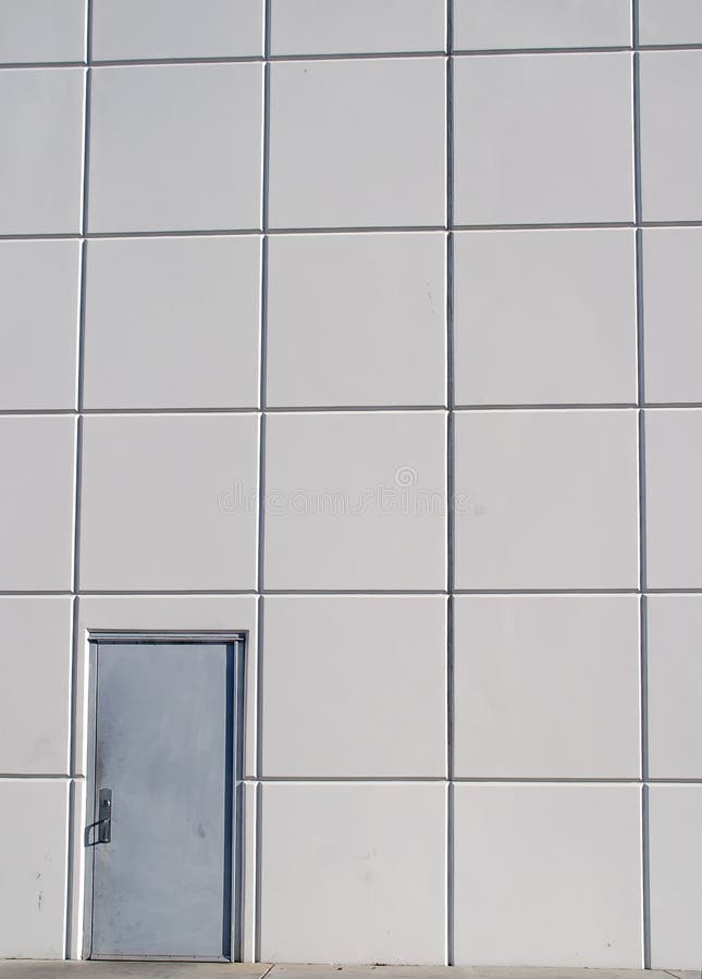 Vertical Image of a Gray Door among Square Pattern on a Large Concrete ...