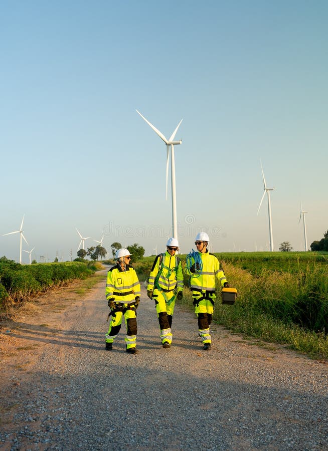Group of Wind Turbines on Green Hillside Stock Photo - Image of hilltop ...
