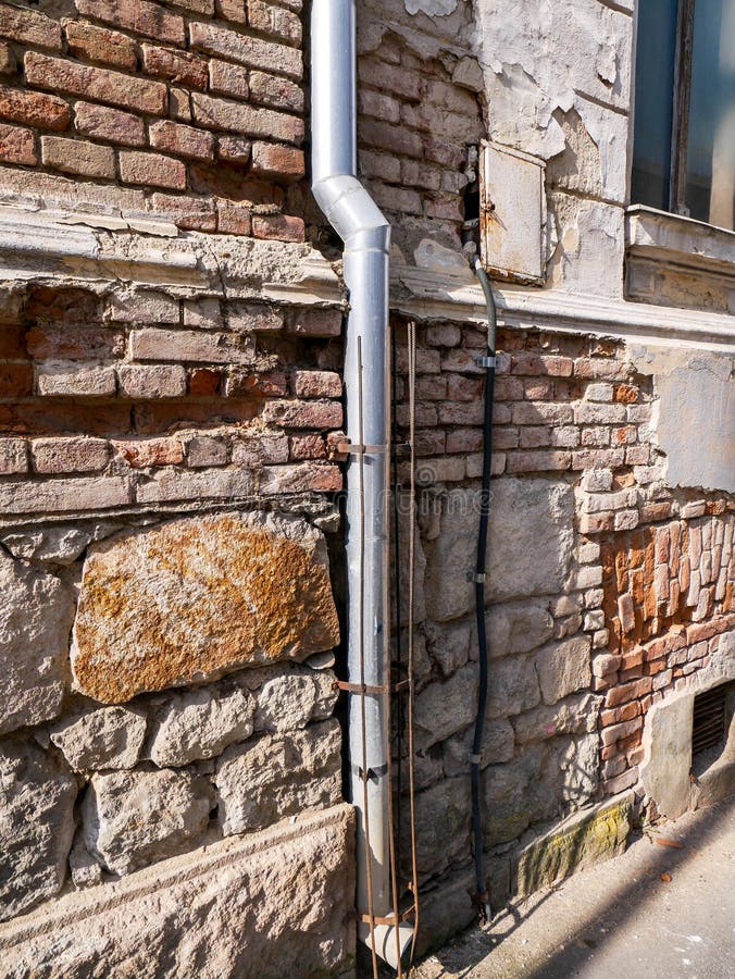 Vertical Image ,gutter on Old Weathered Brick Wall Stock Photo - Image ...
