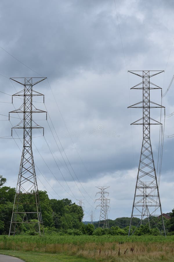 High Voltage Power Lines with Dark Storm Clouds in the Background Stock ...